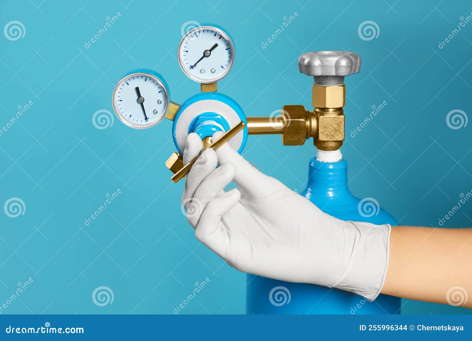 Medical Worker Checking Oxygen Tank on Light Blue Background, Closeup ...