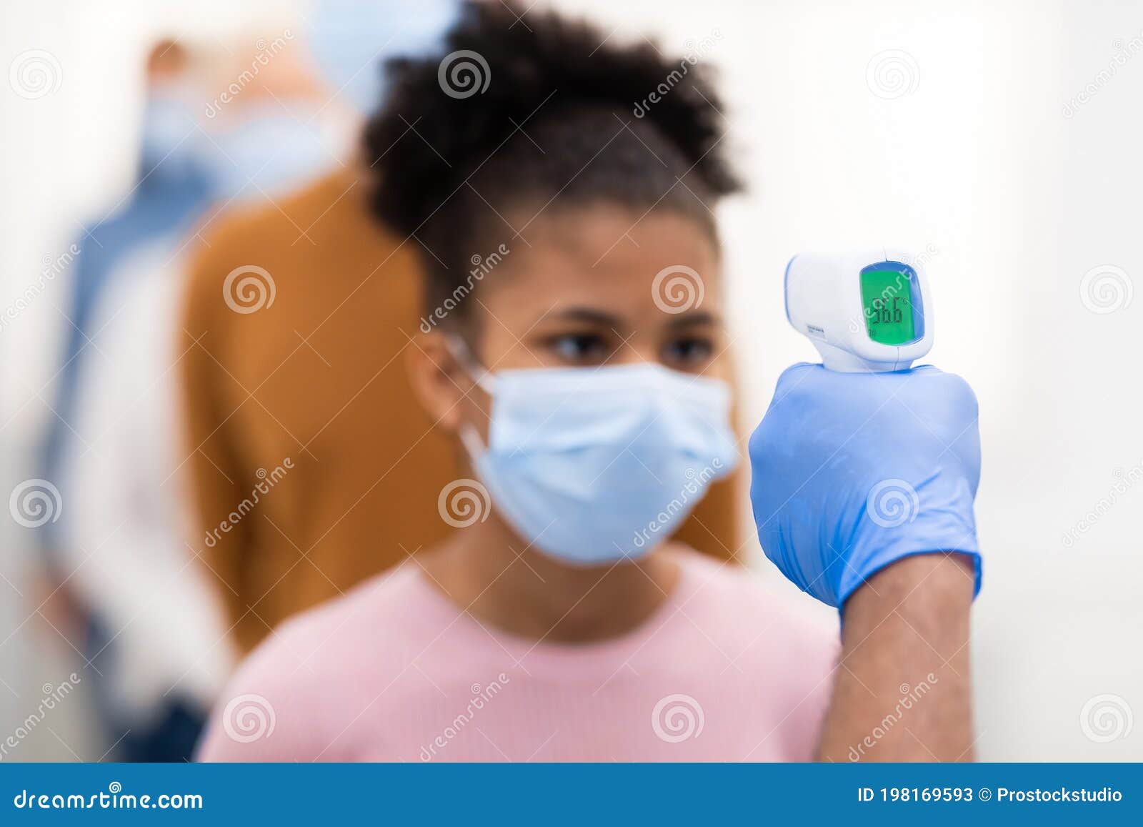 Medical Worker Doing Temperature Screening for People in Queue Indoors ... Medical Worker Doing Temperature Screening for People in Queue Indoors ...