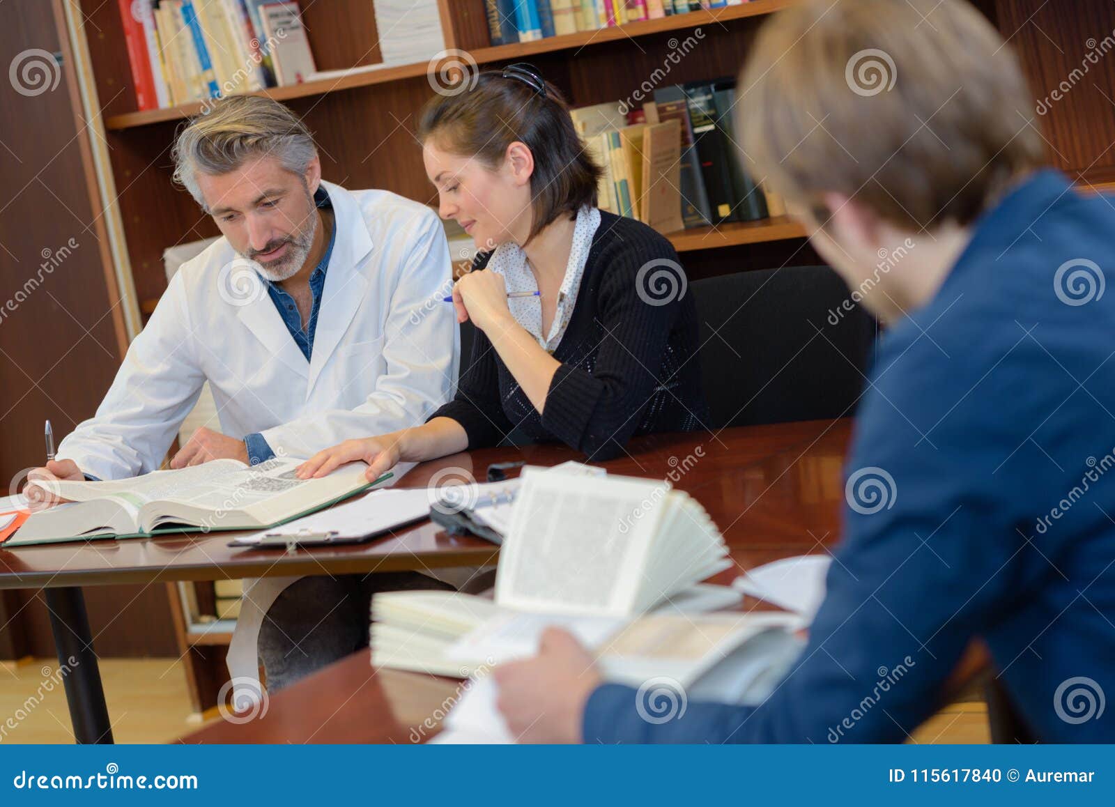 Medical workers in library stock photo. Image of medical - 115617840