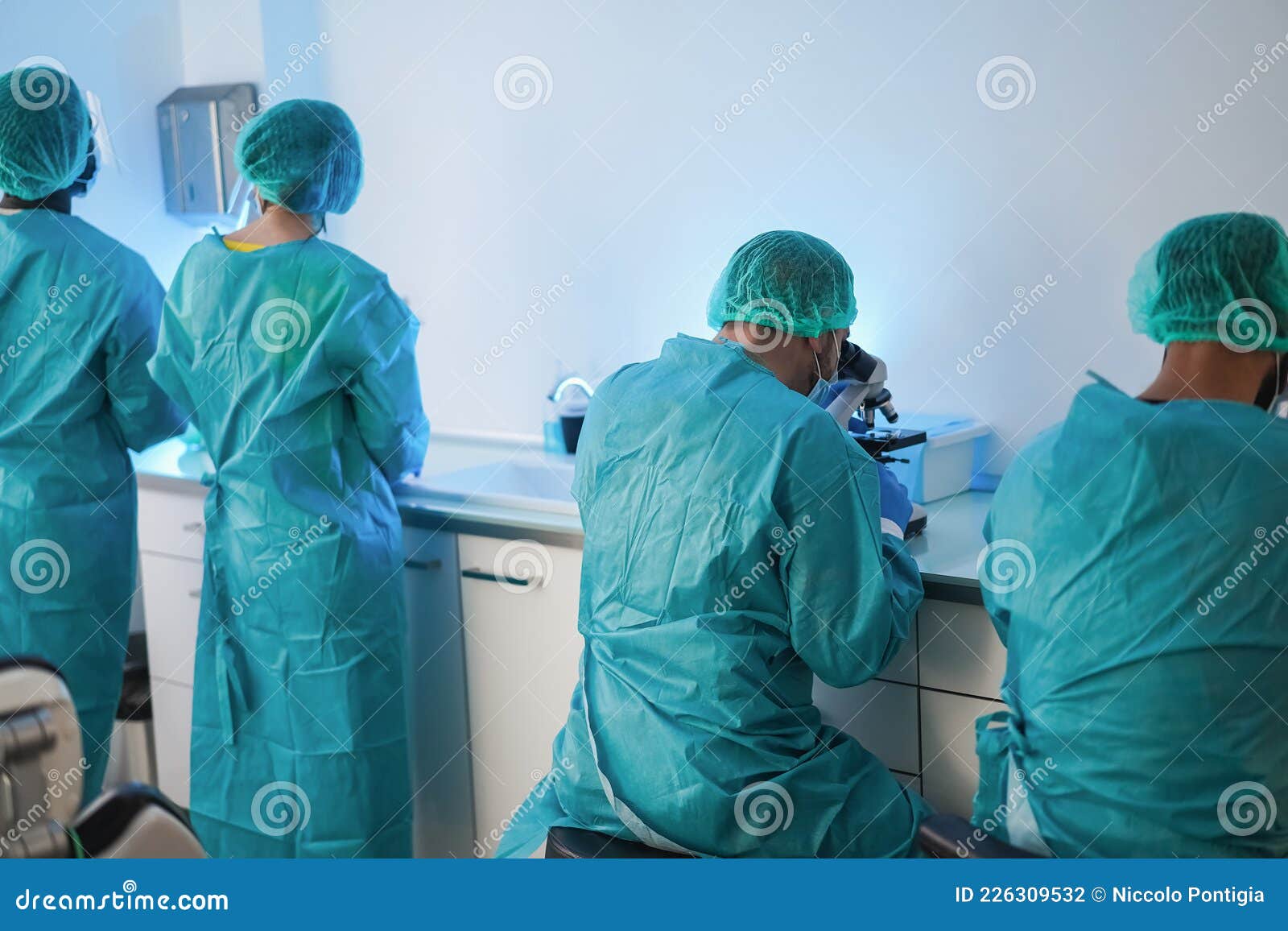Medical Workers Using Microscope and Working Inside Hospital Lab ...