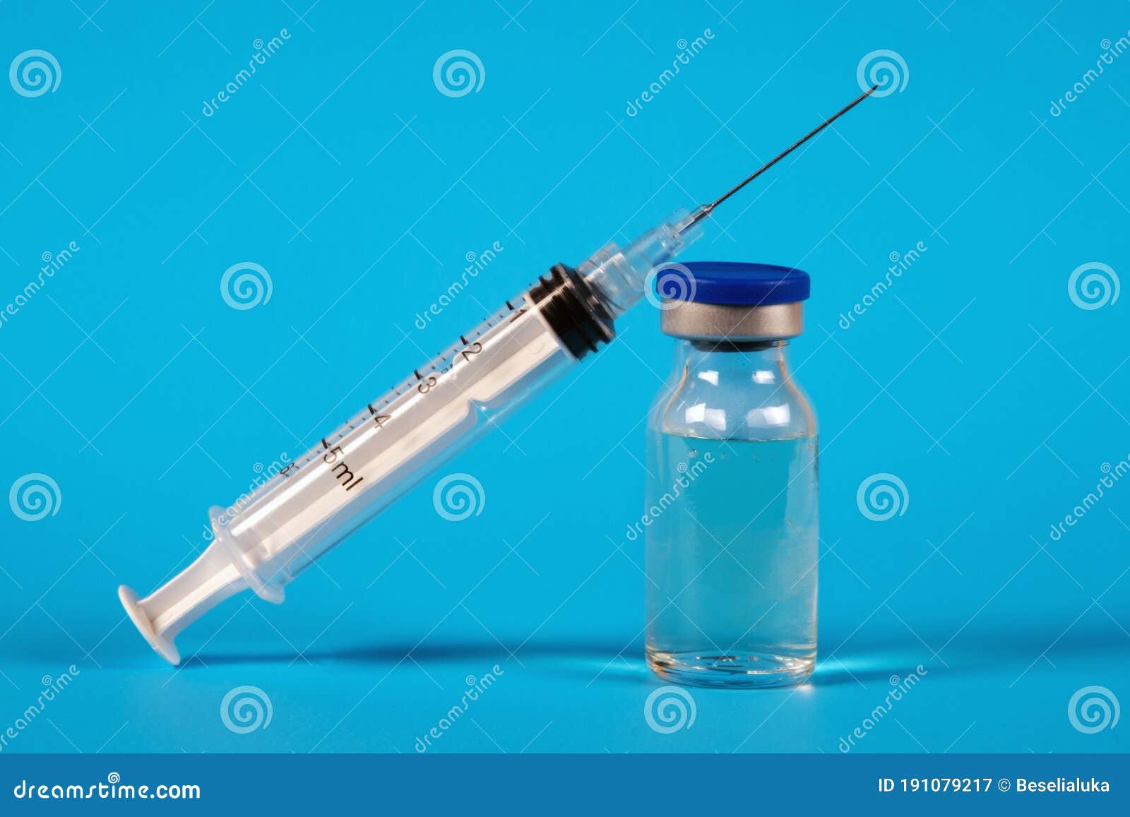 Medicine Bottle for Injection with Syringe for Vaccination on the Blue ...