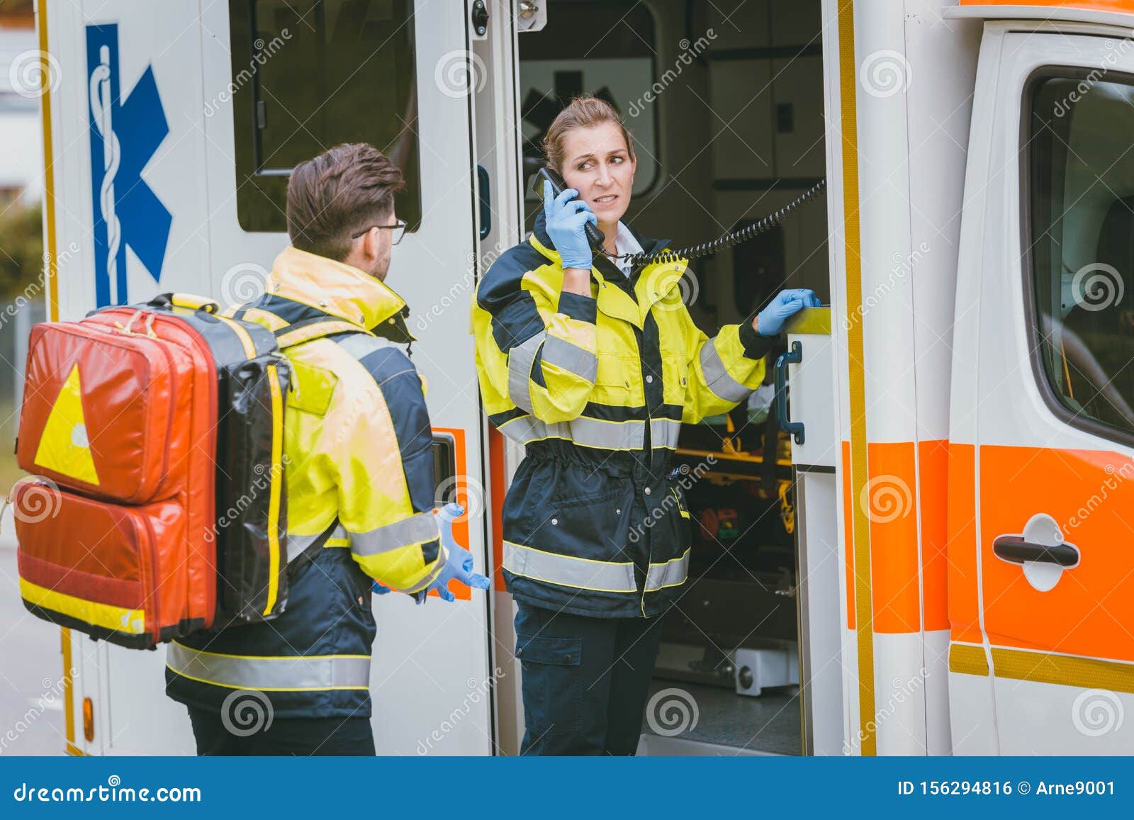 Medics in Front of Ambulance Talking To Headquarters Using Radio Stock ...