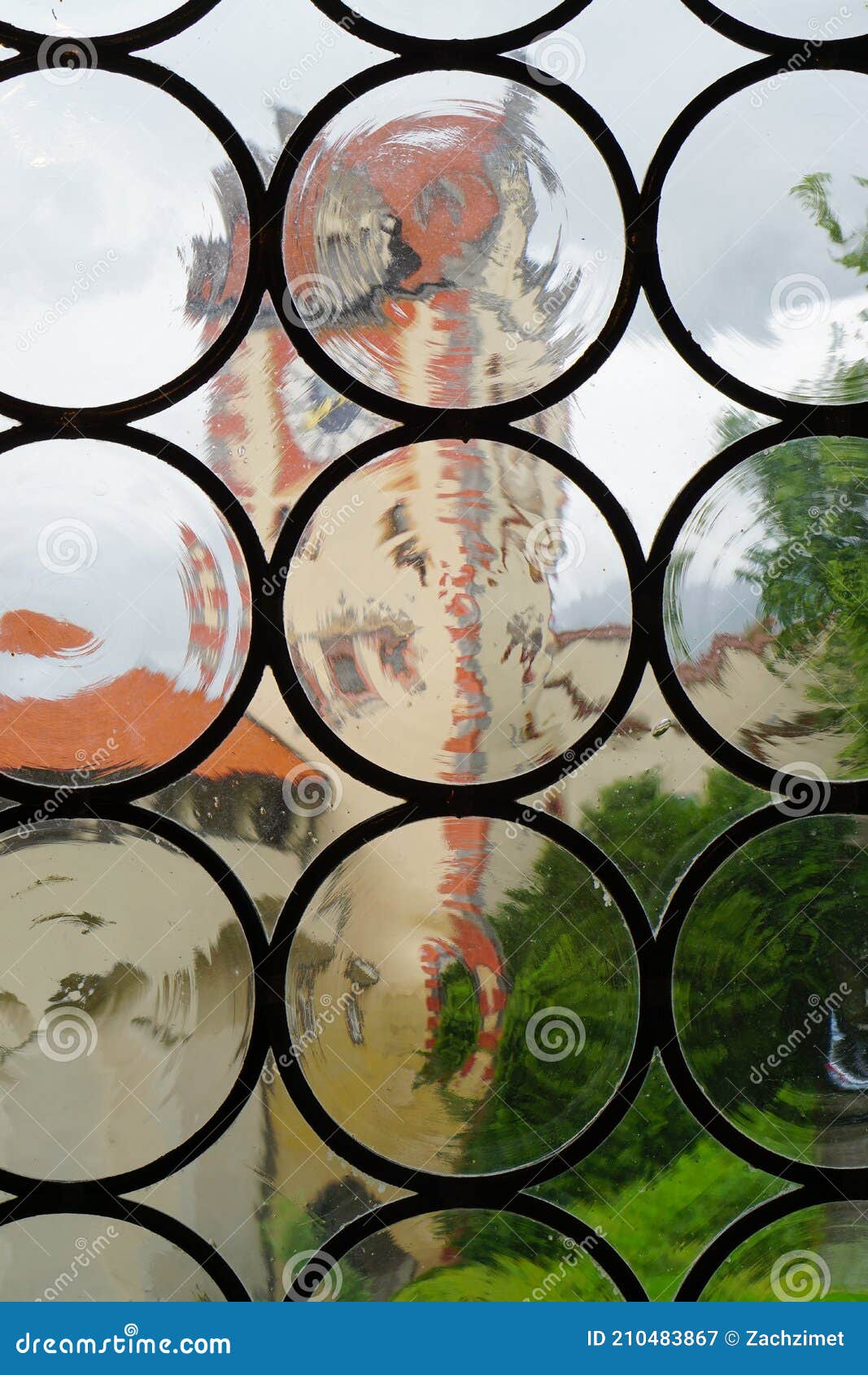 Medieval Clock Tower Viewed through Old Glass Window with Circles Stock ...
