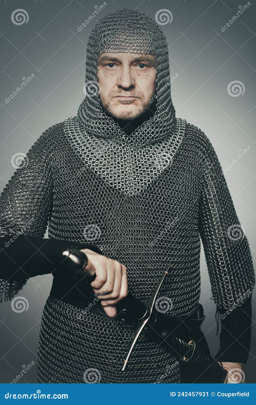 Armed Man in Chain Armor with Sword Posing for Portrait in Studio Stock ...