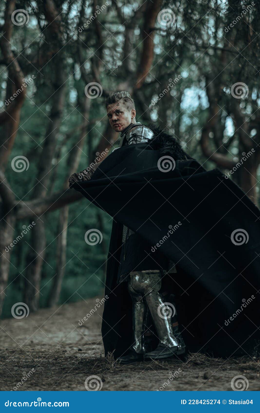 Medieval Knight in Armour and Black Cape Stands in Forest Stock Photo ...