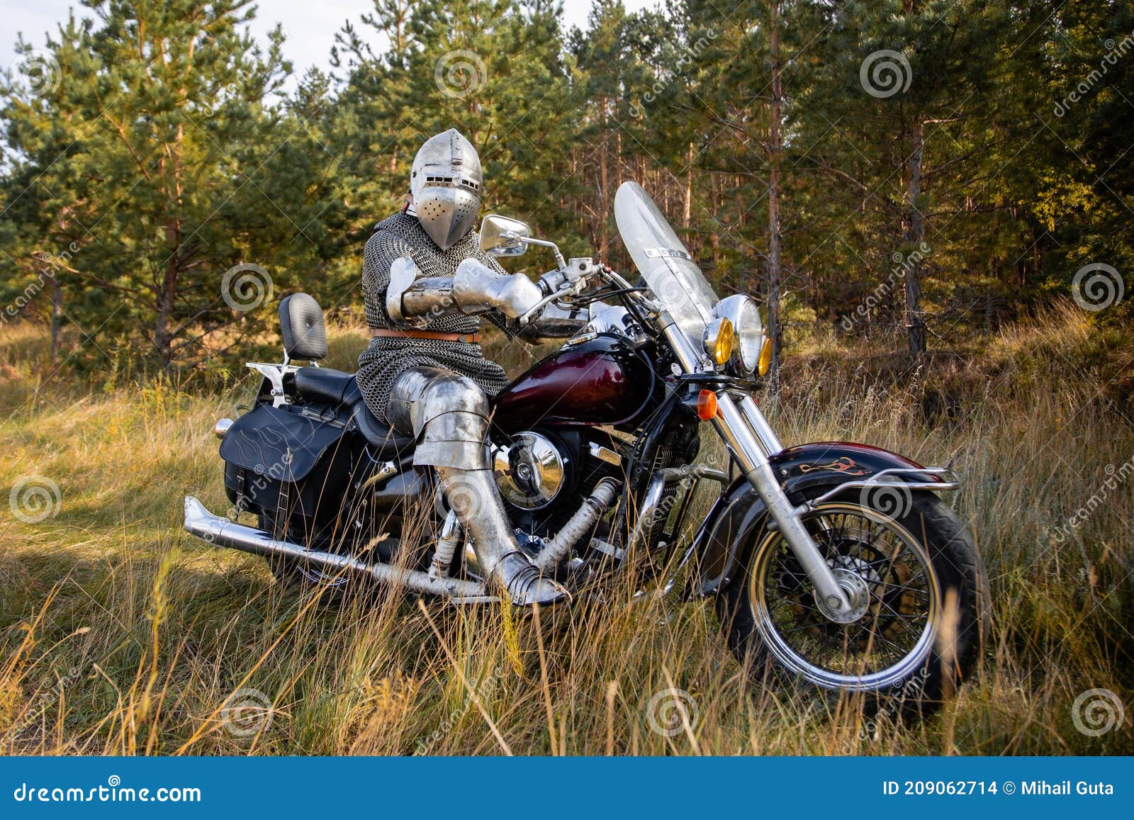 A Medieval Knight in Chain Mail and a Helmet Sits on a Motorcycle ...