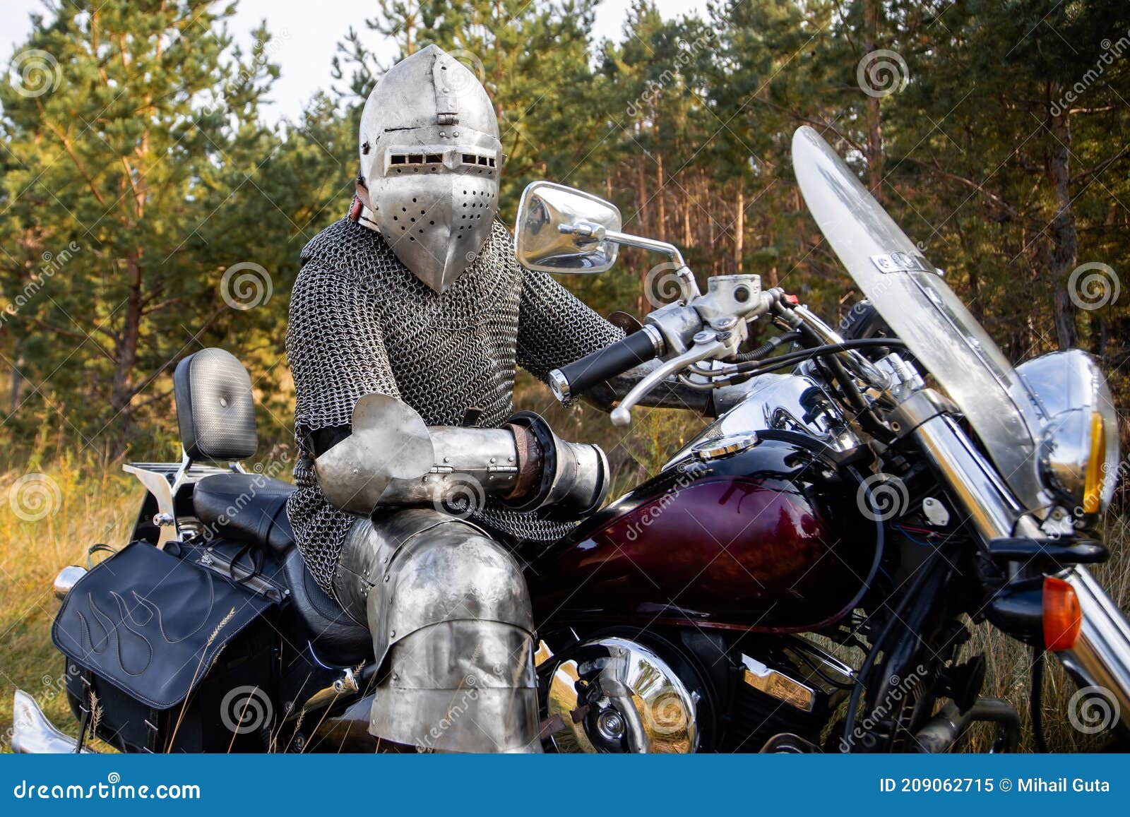 A Medieval Knight in Chain Mail and a Helmet Sits on a Motorcycle ...