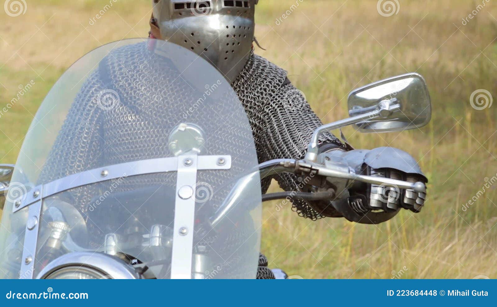 A Medieval Knight in Full Armor Sits on a Motorcycle Against the ...