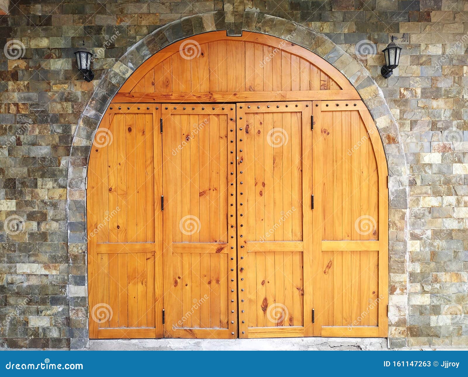 Medieval Looking Arched Top Doors Set in a Stone Castle Wall Stock ...