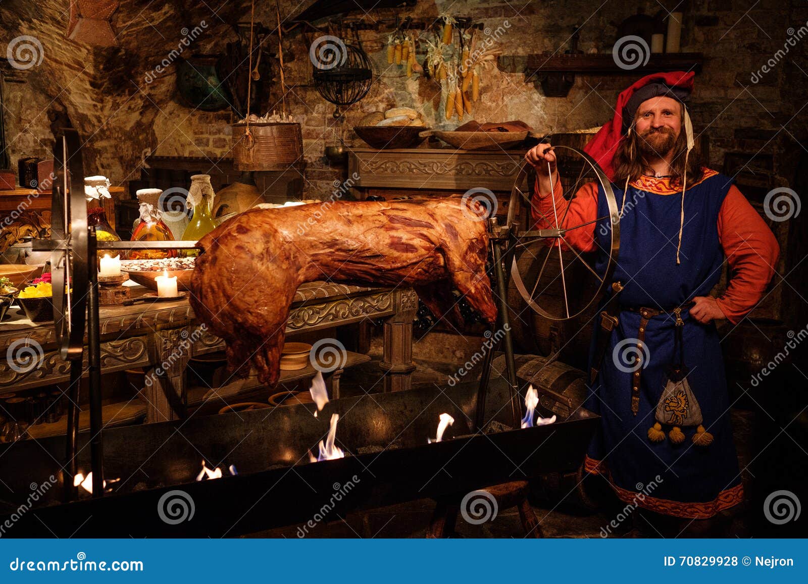 Medieval Man Doing Roasted Pig on the Rack in Ancient Castle Kit Stock ...