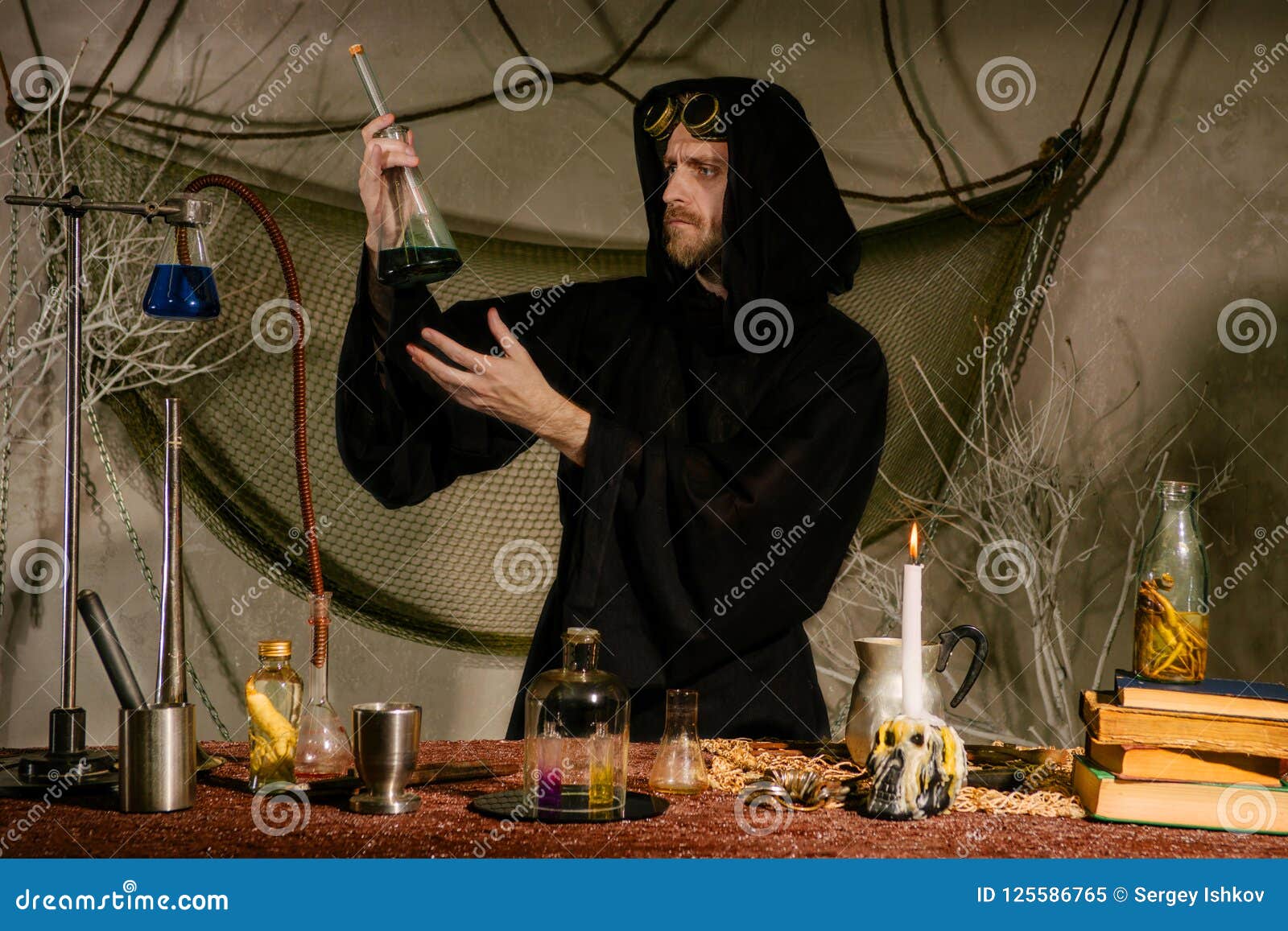 A Medieval Scientist, an Alchemist, Measures Temperatures in a Flask in ...