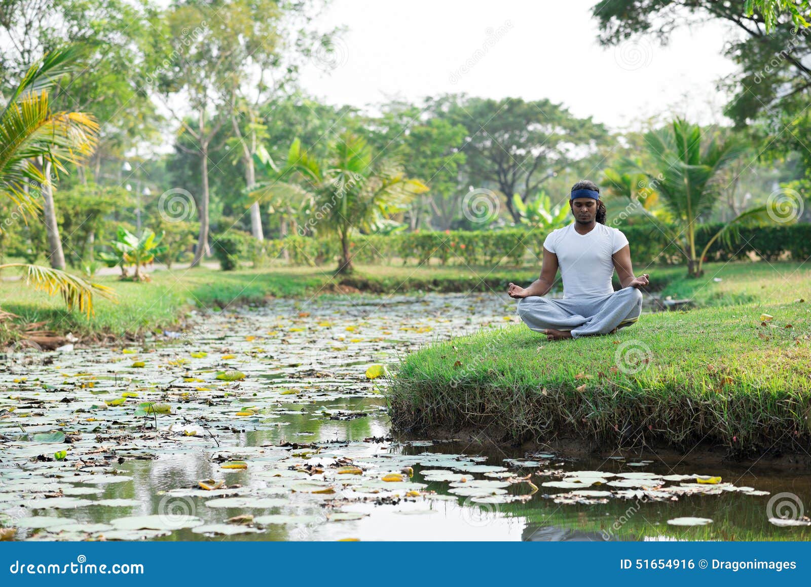 Meditating near the river stock photo. Image of spirituality - 51654916