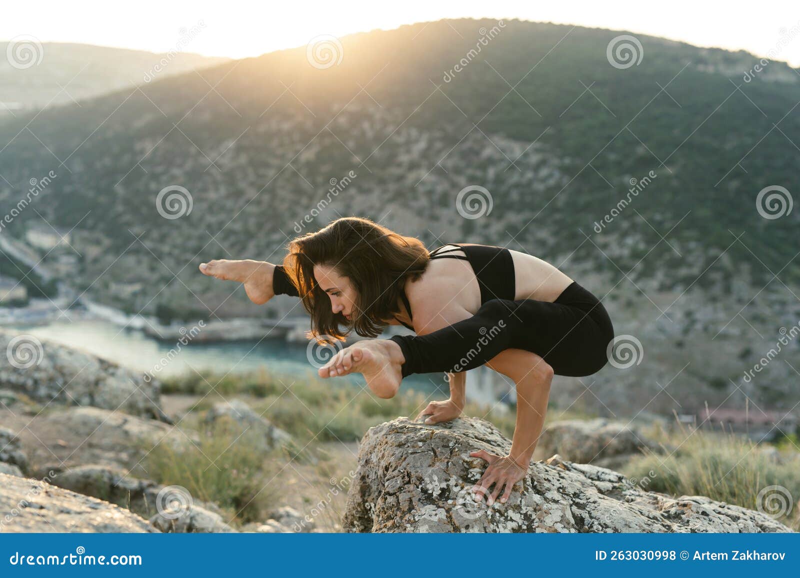 Meditation in a Complex Yoga Pose on a Huge Stone Overlooking the Sea ...