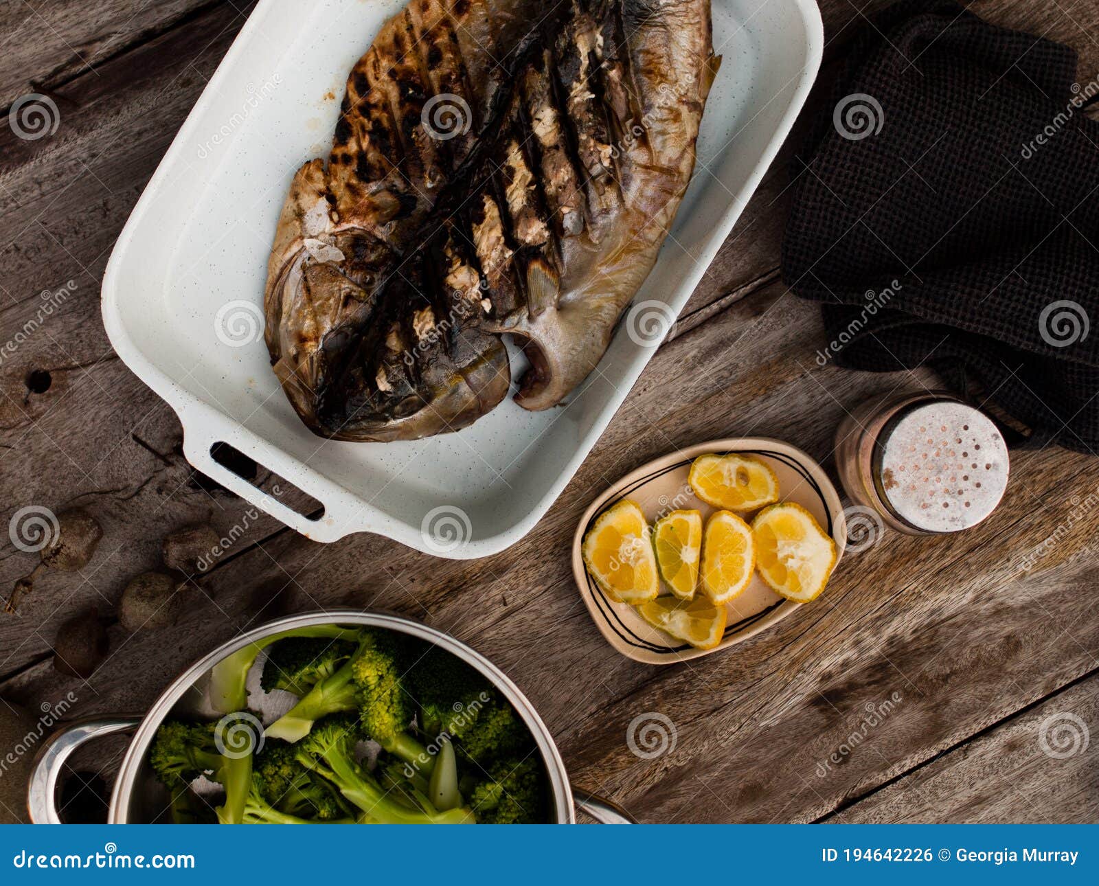 Mediterranean Fire Cooked Fish on Rustic Wooden Table Stock Photo ...