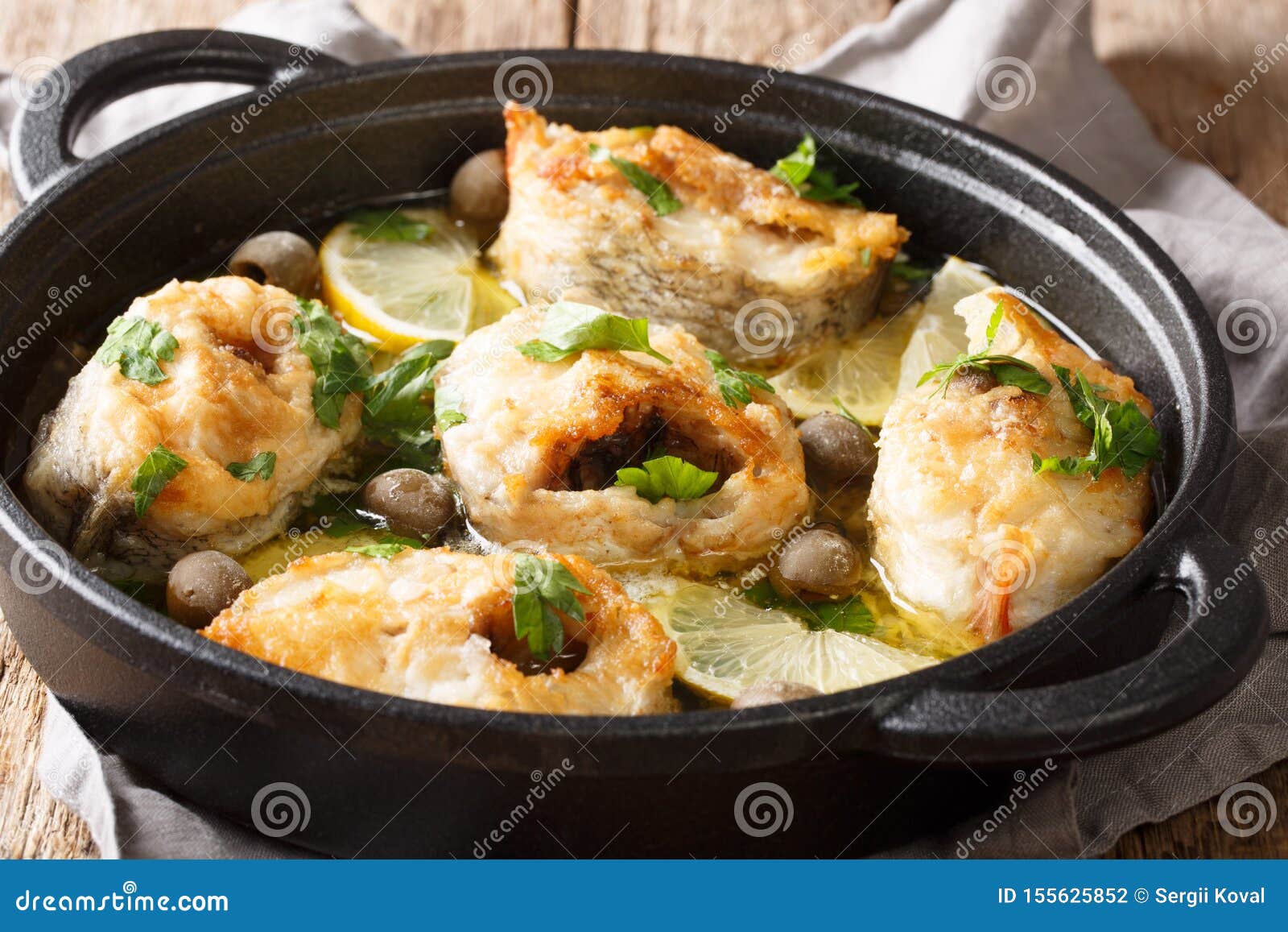 Mediterranean Pieces of Cod Baked with Lemon and Olives Close-up in a ...
