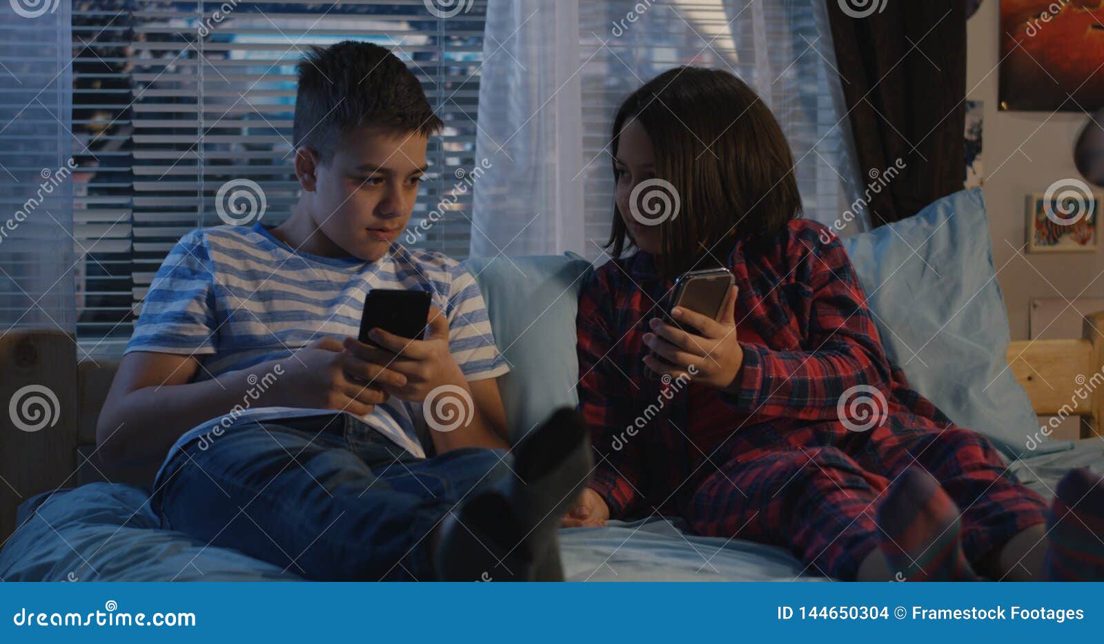 Siblings talking at night stock photo. Image of room - 144650304
