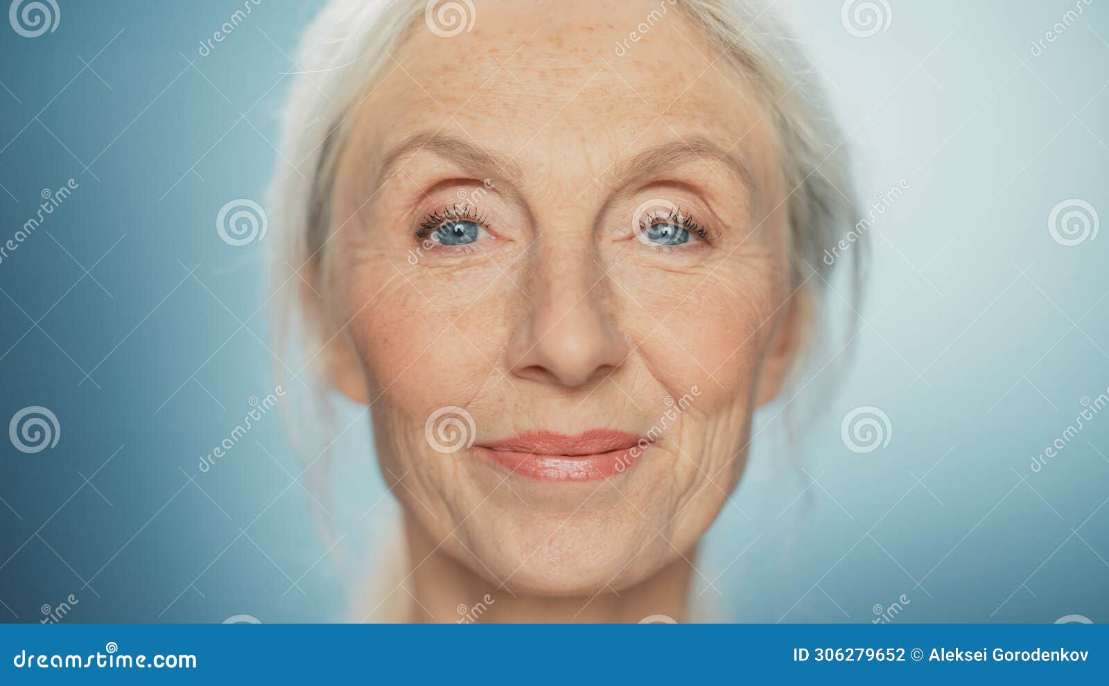 Medium Portrait Of Beautiful Senior Woman Looking At Camera And Smiling
