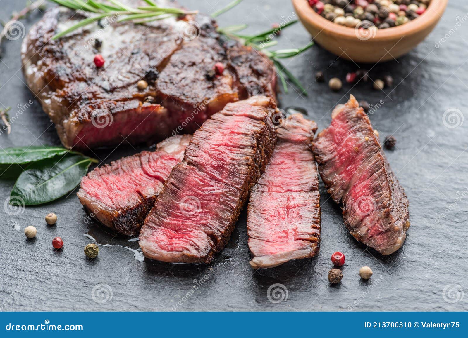 Medium Rare Ribeye Steak with Herbs on Graphite Board Stock Photo ...