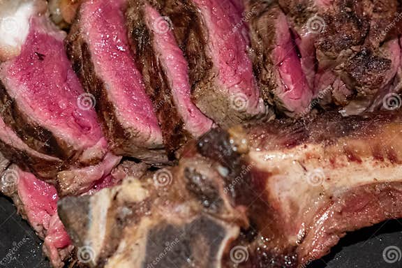 Medium rare Tomahawk meat stock image. Image of cutting - 280056315