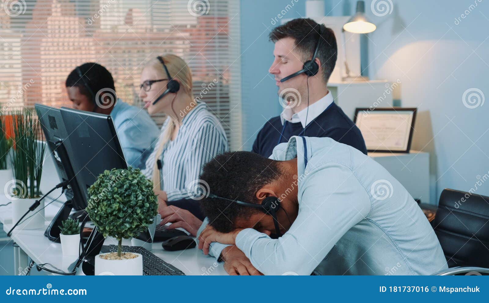 Medium Shot of Black Customer Support Operator Falling Asleep on His ...