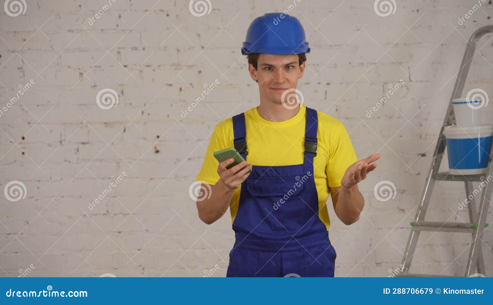 Medium Shot of a Construction Worker Standing in the Room, Holding a ...