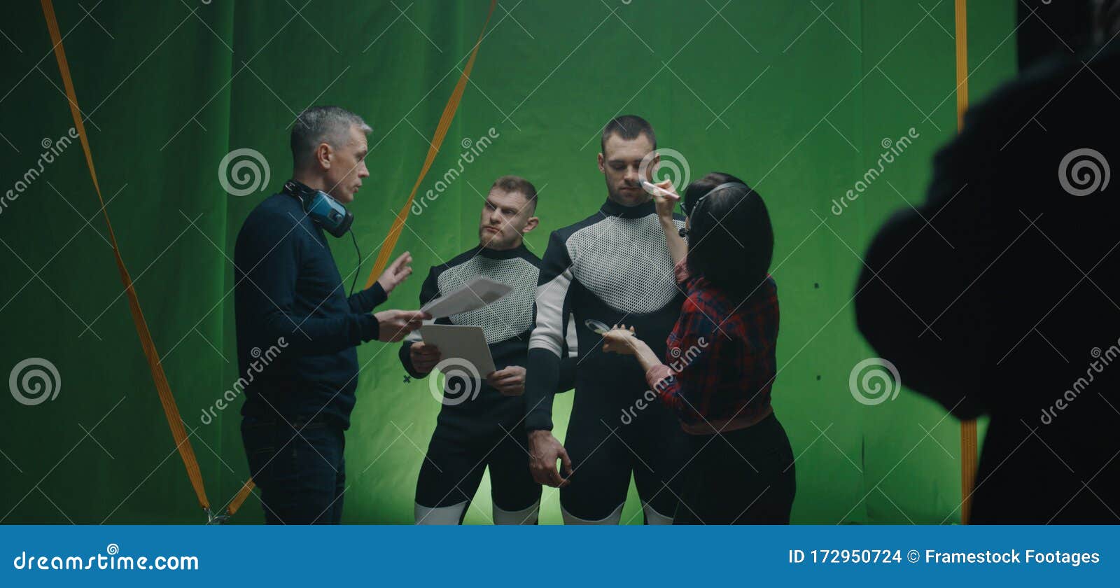 Cosmetician Preparing an Actor while Others Discussing the Scene Stock ...