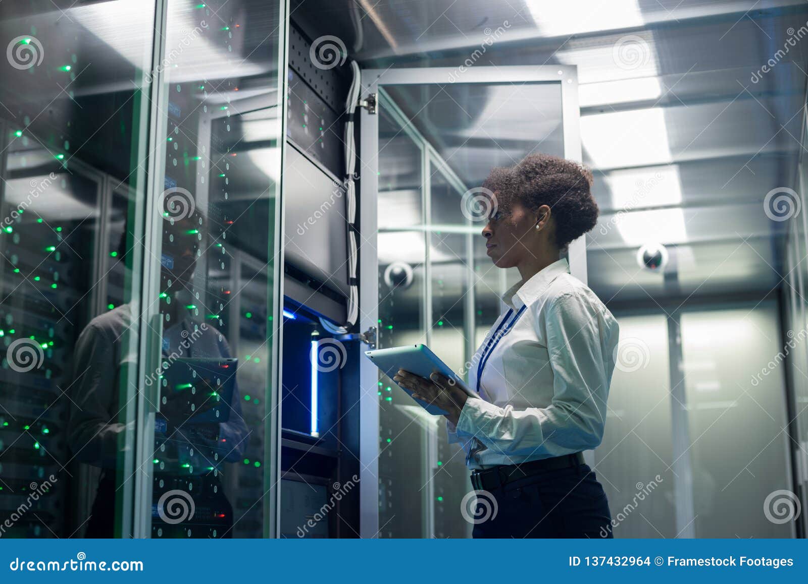 Female Technician Works on a Tablet in a Data Center Stock Photo ...
