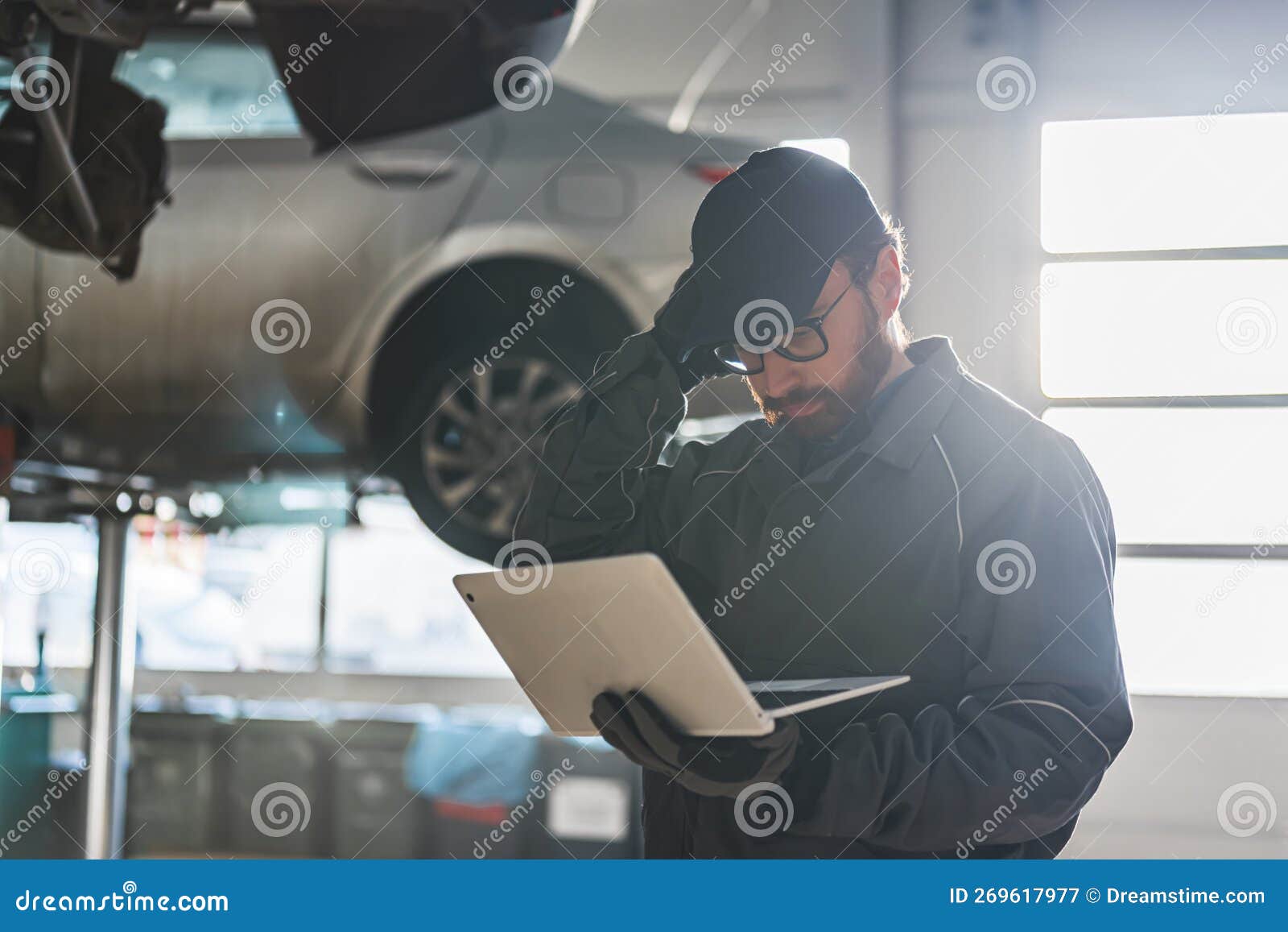 Medium Shot. a Mechanic Struggling with a Problem with Car System ...