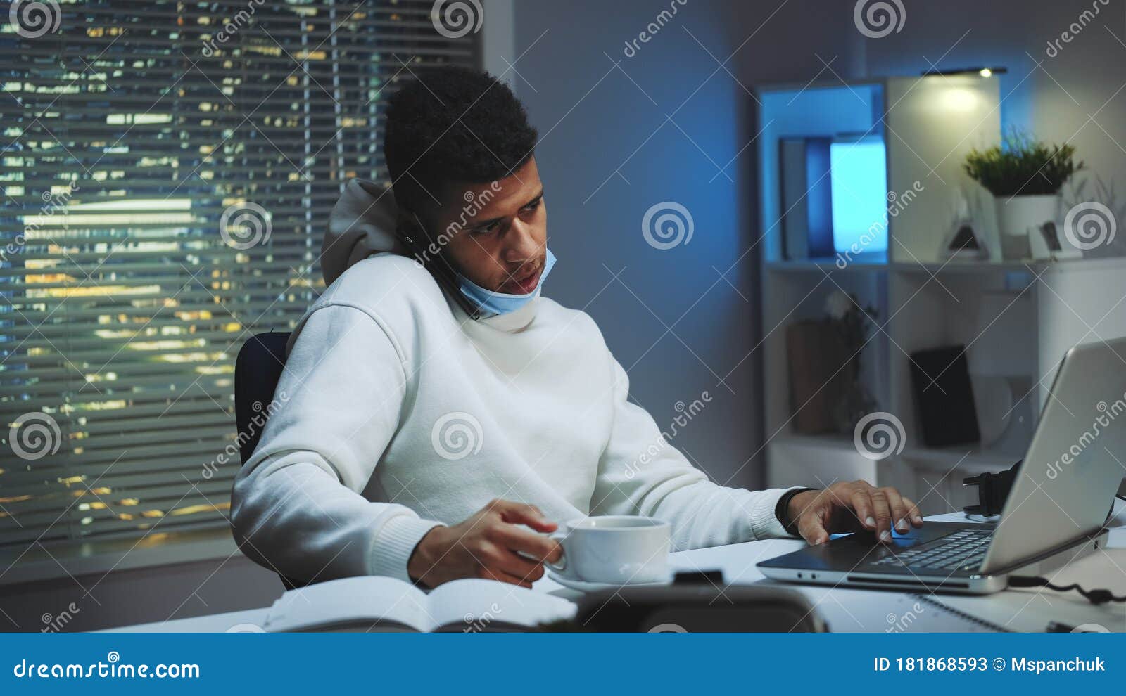Medium Shot of Mixed-race Man Working on Computer, Speaking by ...