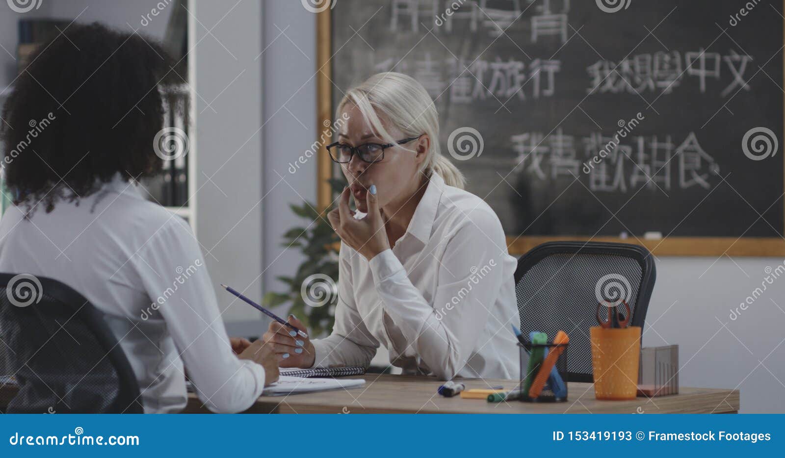 Teacher Explaining To Student in the Classroom Stock Image - Image of ...