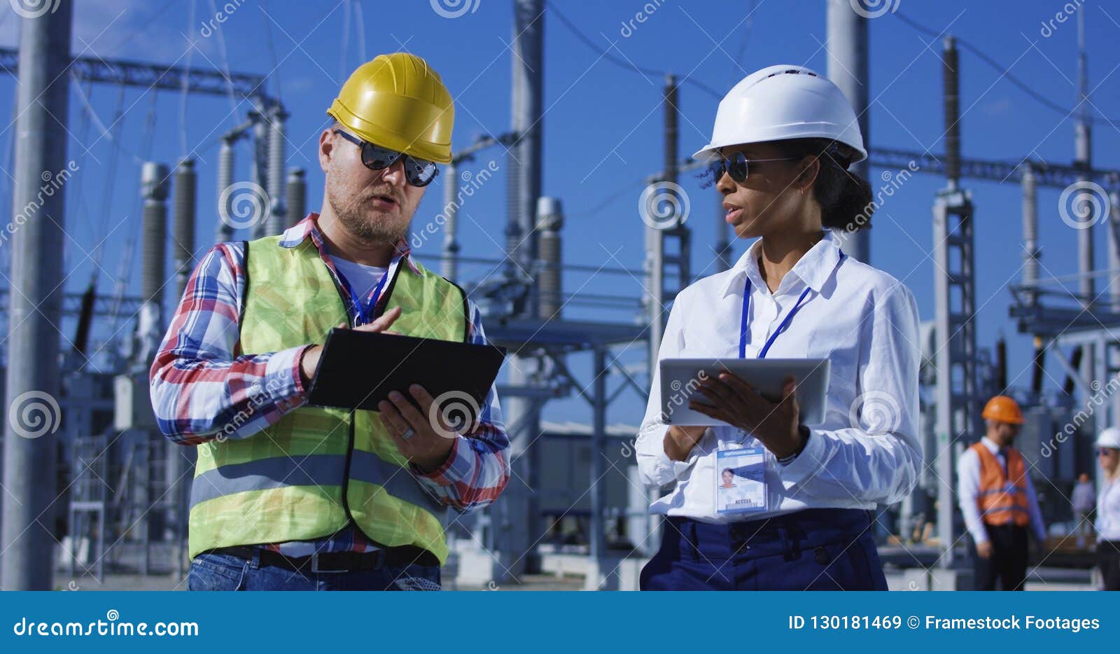 Two Electrical Workers on Tablets Outside Stock Image - Image of ...