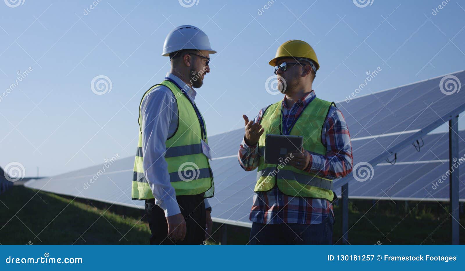 Two Electrical Workers Reviewing Documents on a Tablet Stock Image ...