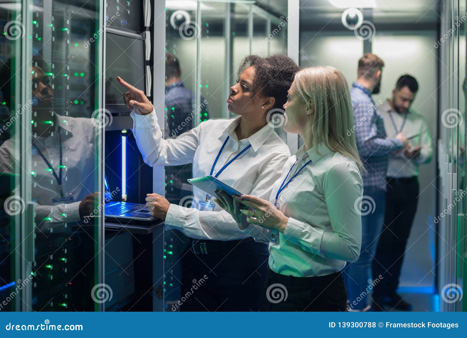 Two Women are Working in a Data Center with Rows of Server Racks Stock ...