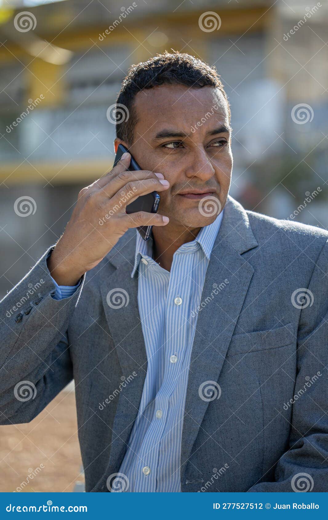 Medium Shot of a Young Latino Man Talking on the Phone Stock Photo ...