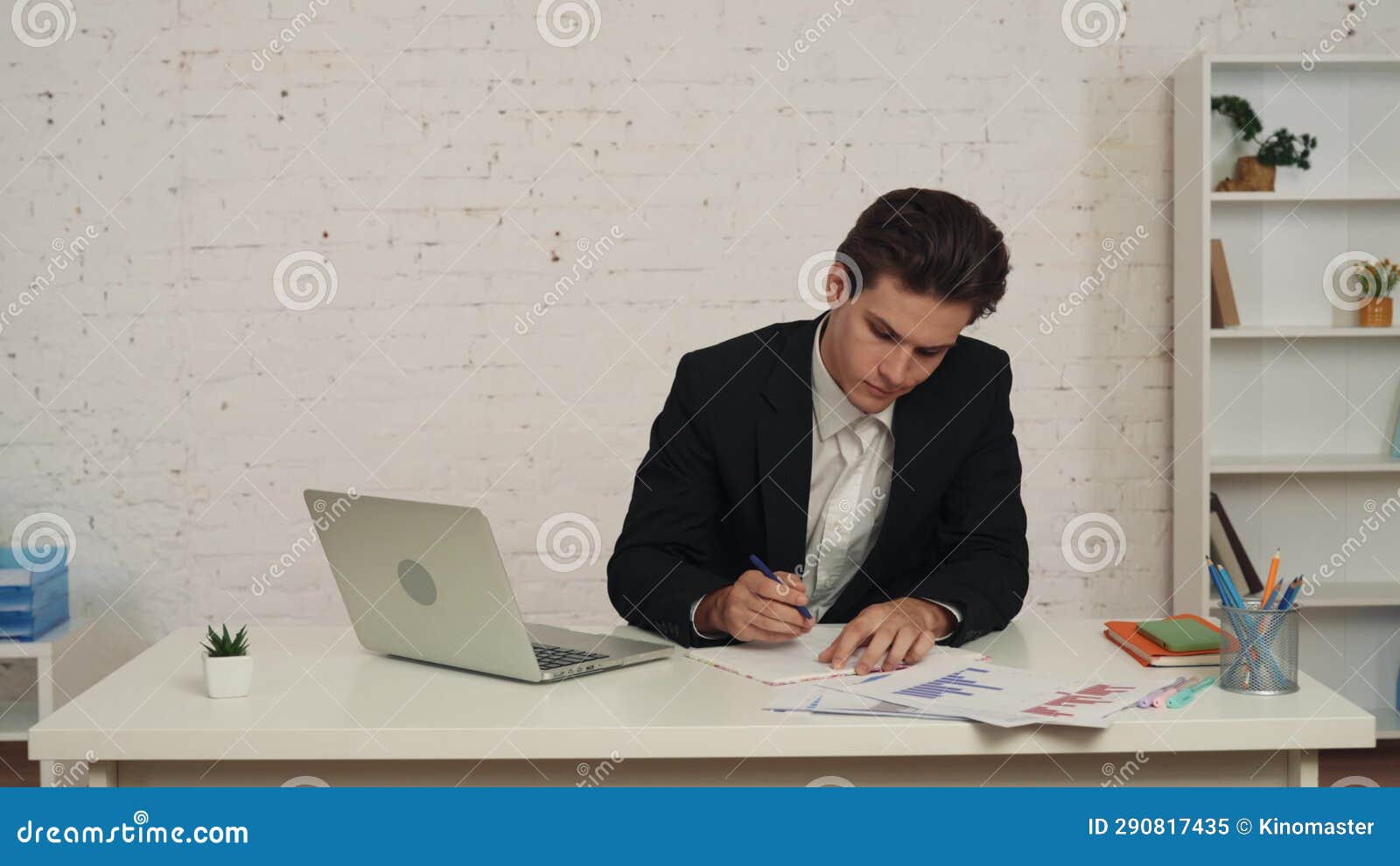 Medium Video of a Young Man Sitting in the Office, Working on a Laptop ...
