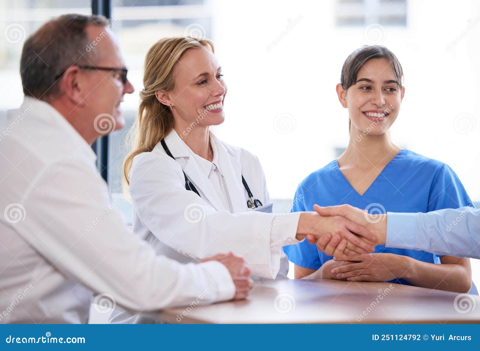 Meeting New Doctors. Shot of Two Doctors Shaking Hands in a Meeting at ...