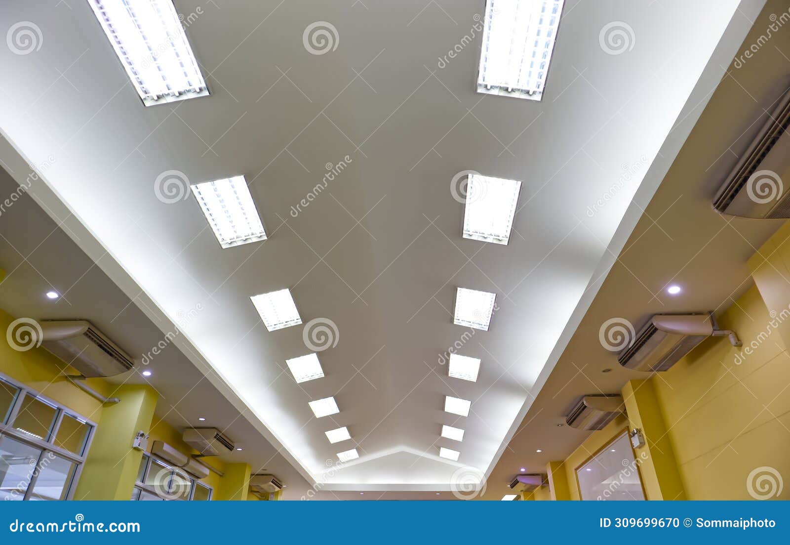 A Meeting Room with Rows of Ceiling Light Boxes and Air Conditioners ...