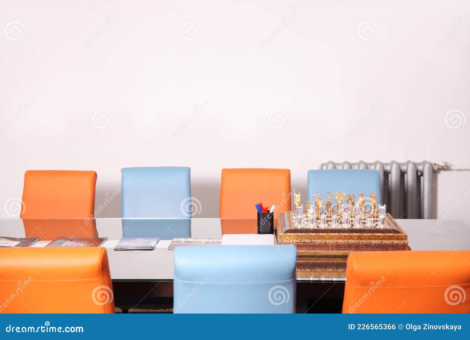 Meeting Table in the Office with Bright Blue and Orange Chairs Stock ...
