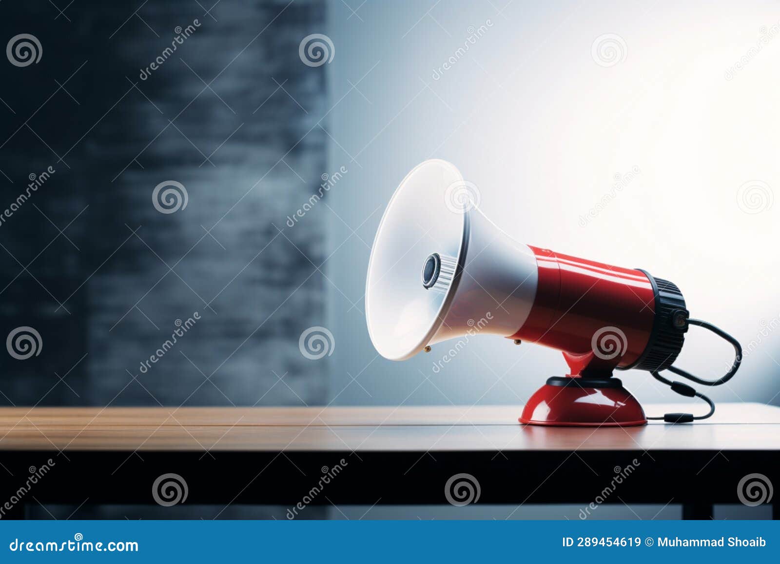 A Megaphone and Microphone Rest on a Table beside a Copy Space Banner ...