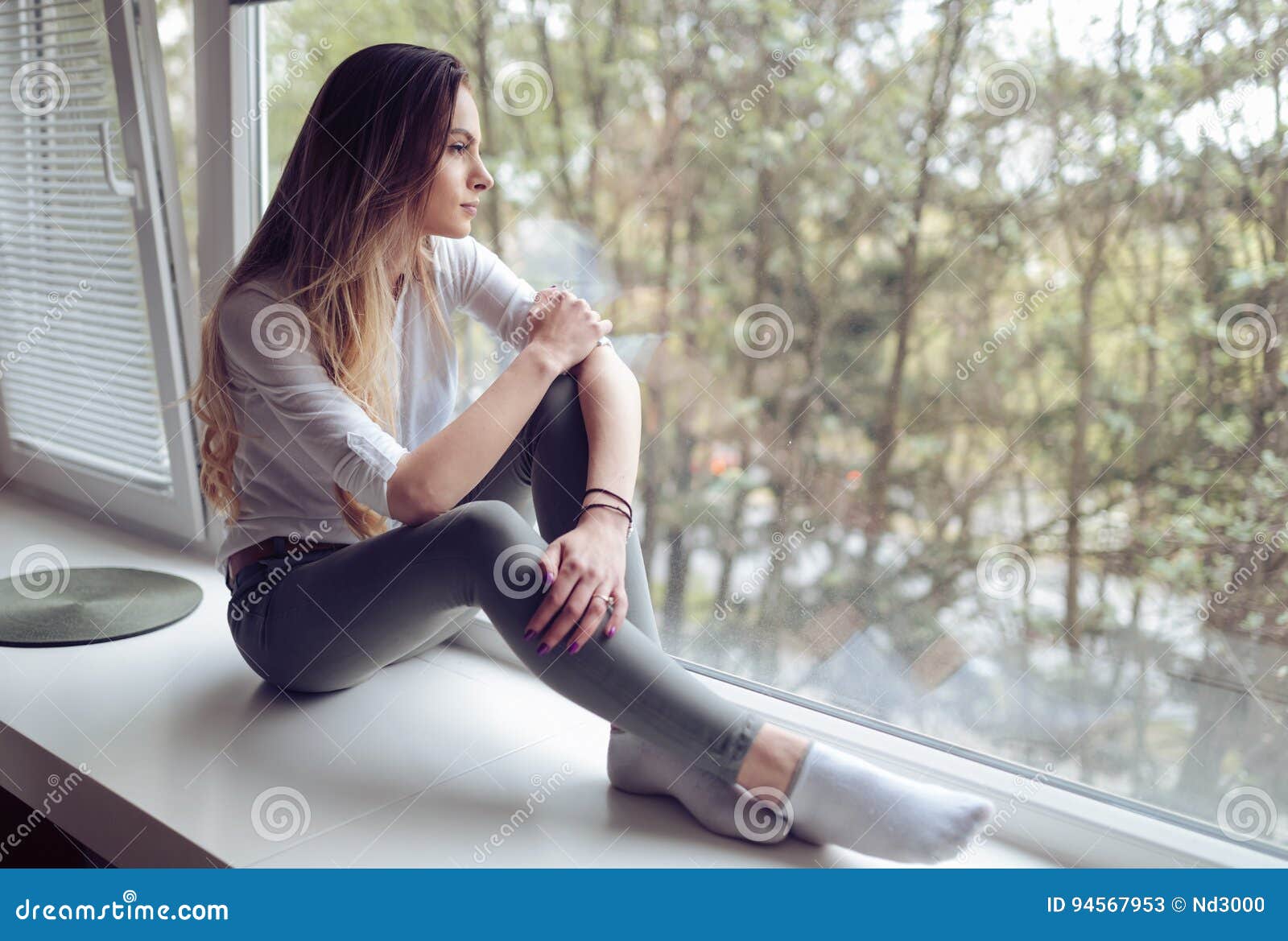Melancholic Woman Sitting on Window Ledge at Home Stock Image - Image ...