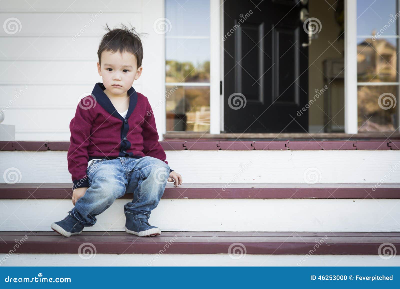 Melancholy Mixed Race Boy Sitting On Front Porch Steps Stock ...