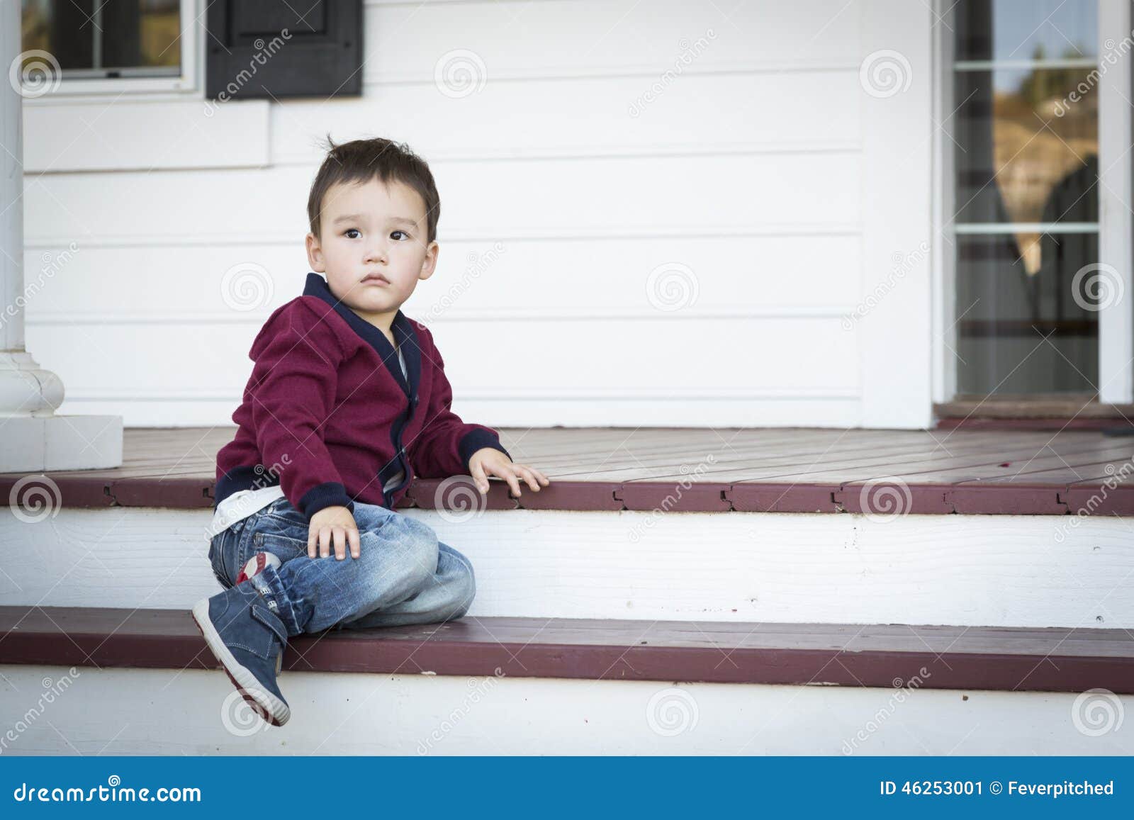 Melancholy Mixed Race Boy Sitting on Front Porch Steps Stock Image ...