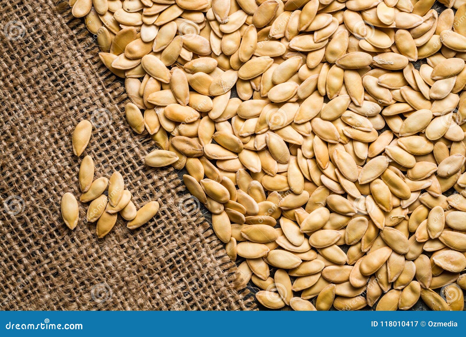 Melon Seeds on Sack Cloth and Table Background Stock Image - Image of ...