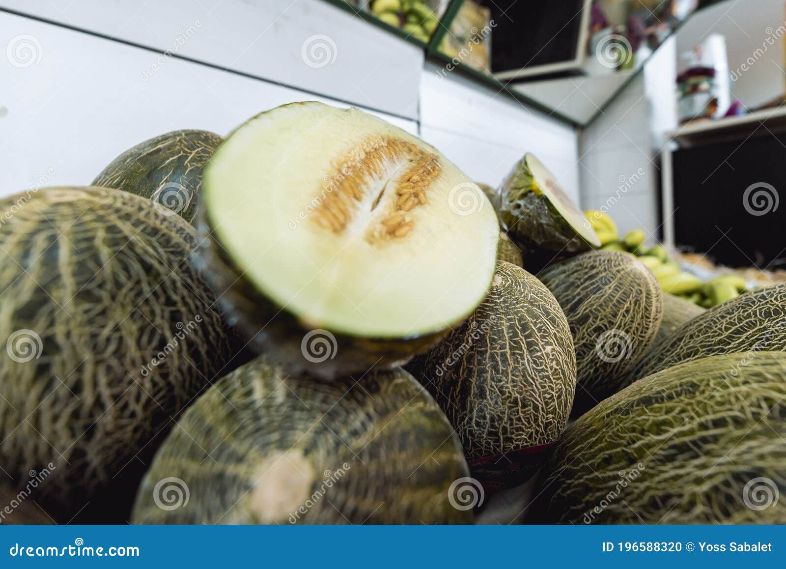 A Melon Split in Half on a Pile of Melons Stock Photo - Image of ...