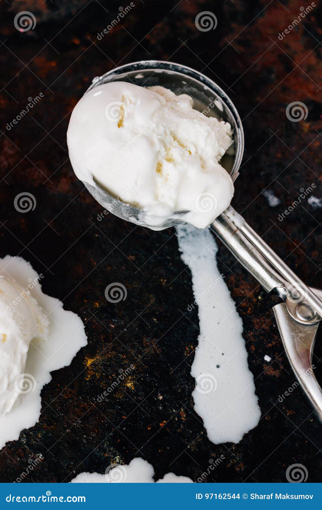Melted Ice Cream in Metal Ice Cream Scooper Over Black Rustic Table ...