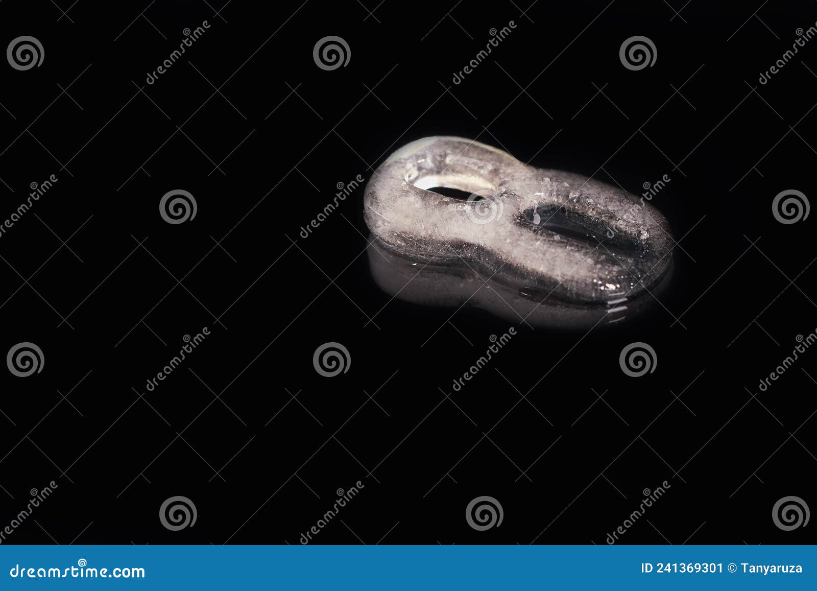 A Melted Ice Figure Eight on a Black Background with a Reflection Stock ...