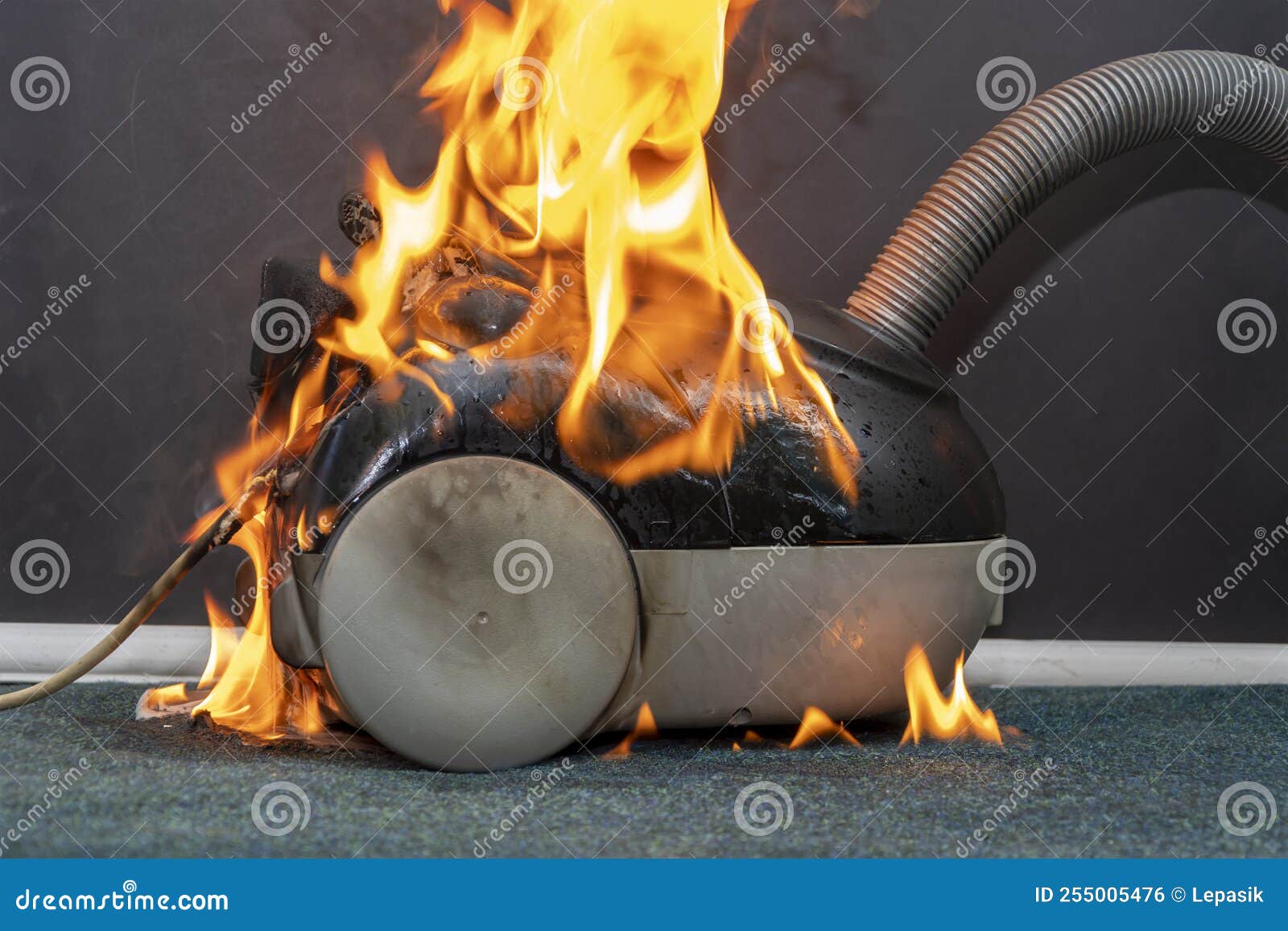 A Melted Vacuum Cleaner on Fire on the Floor in the Apartment, the Fire ...