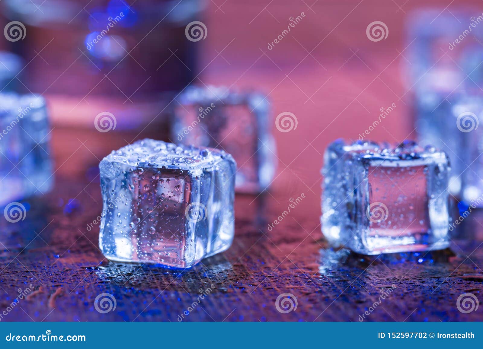 Melting Ice Cubes on a Wooden Table. Close-up Stock Photo - Image of ...
