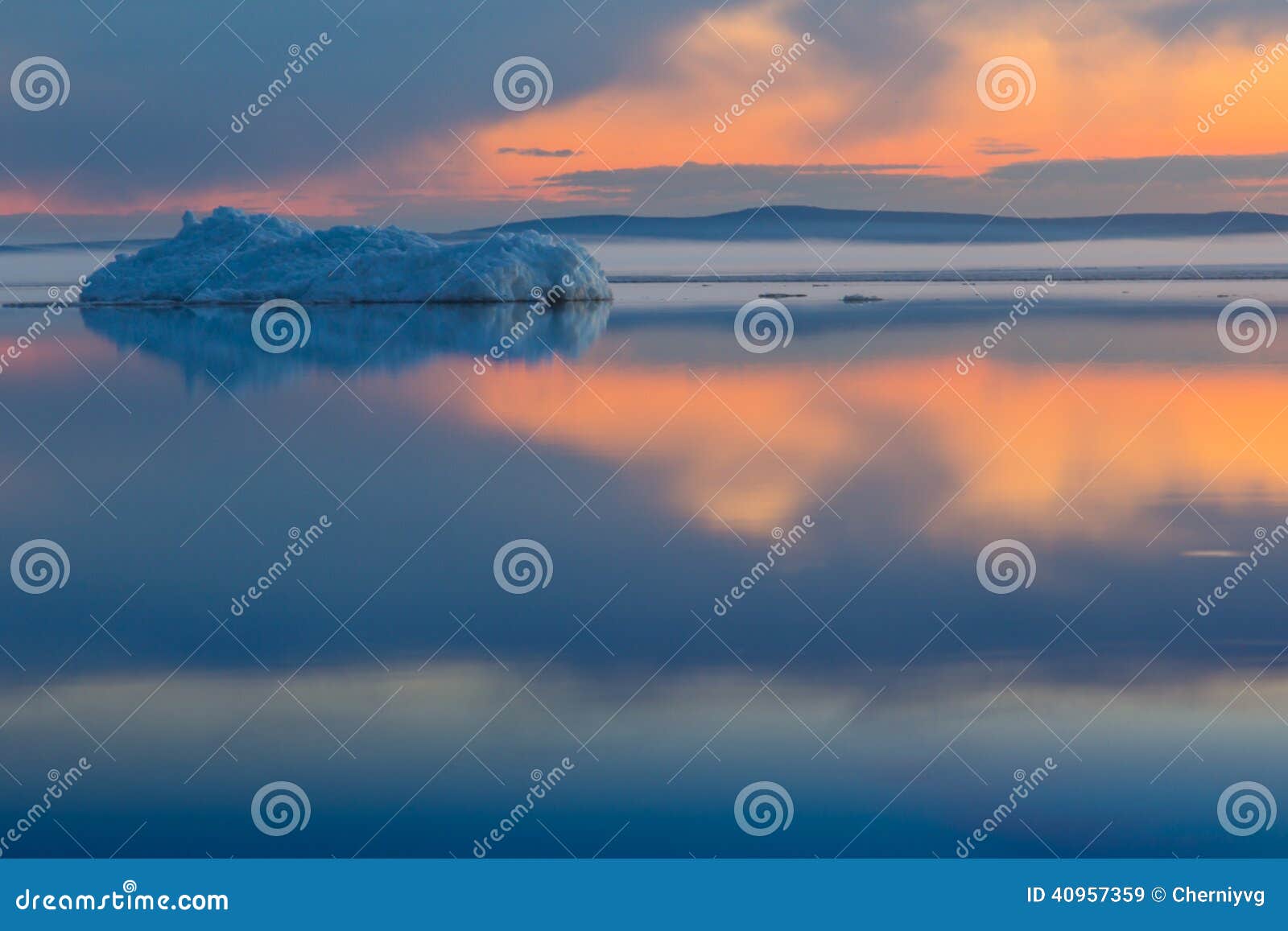 The Melting Iceberg on Spring Mountain Lake in the Setting Sun. Stock ...