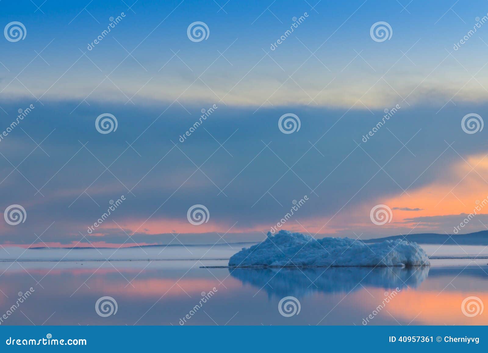 The Melting Iceberg on Spring Mountain Lake in the Setting Sun. Stock ...